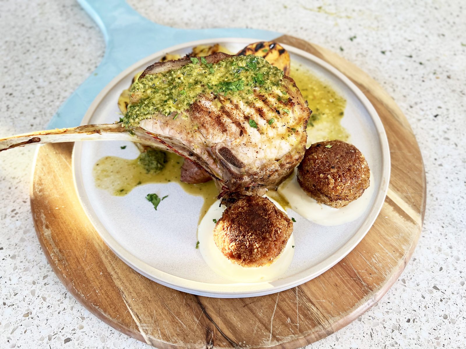 Smoked pork tomahawks with West Indian salsa verde, grilled sweet ...